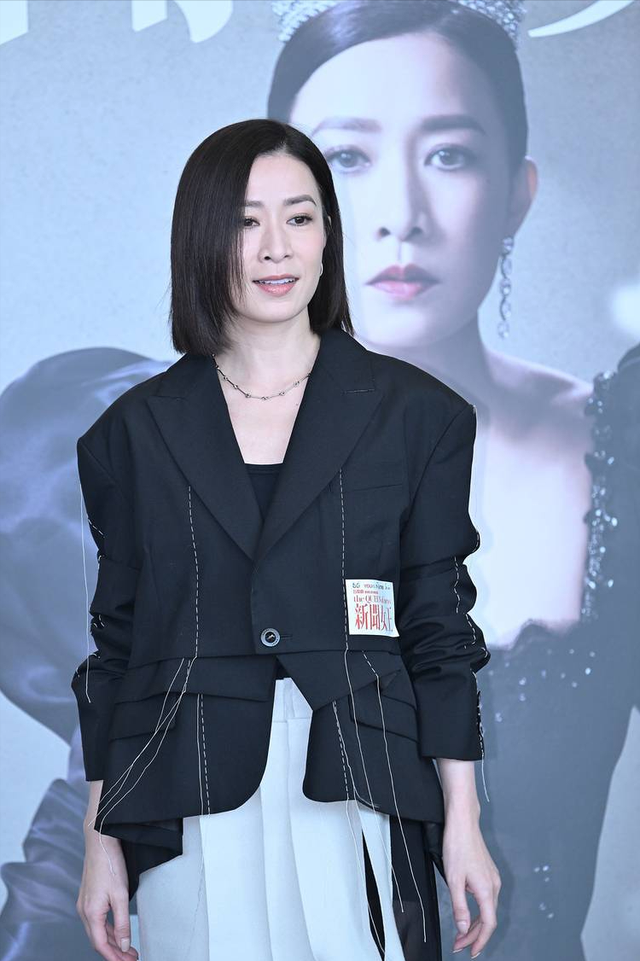 Charmaine Sheh wears a blue slim-fitting long dress, looking like a ...